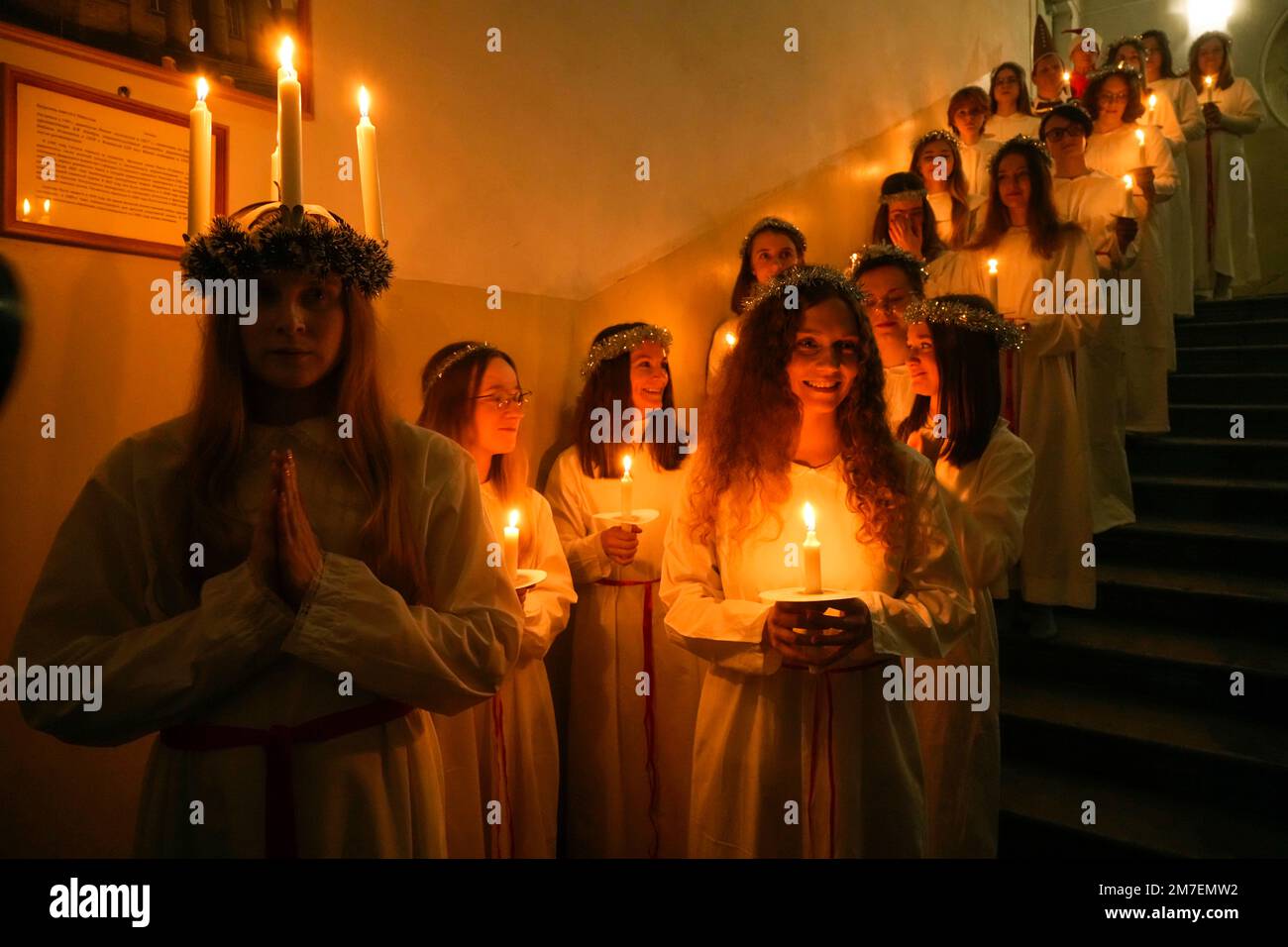 Young women walk with candles in procession to celebrate St. Lucia's ...