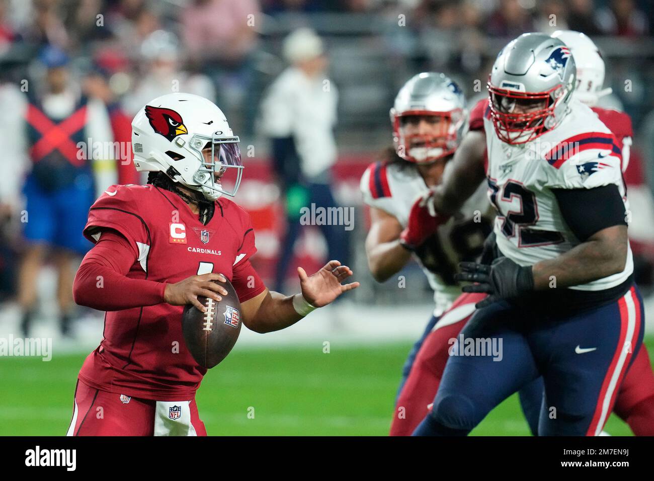 Arizona Cardinals quarterback Kyler Murray, left, scrambles away from ...