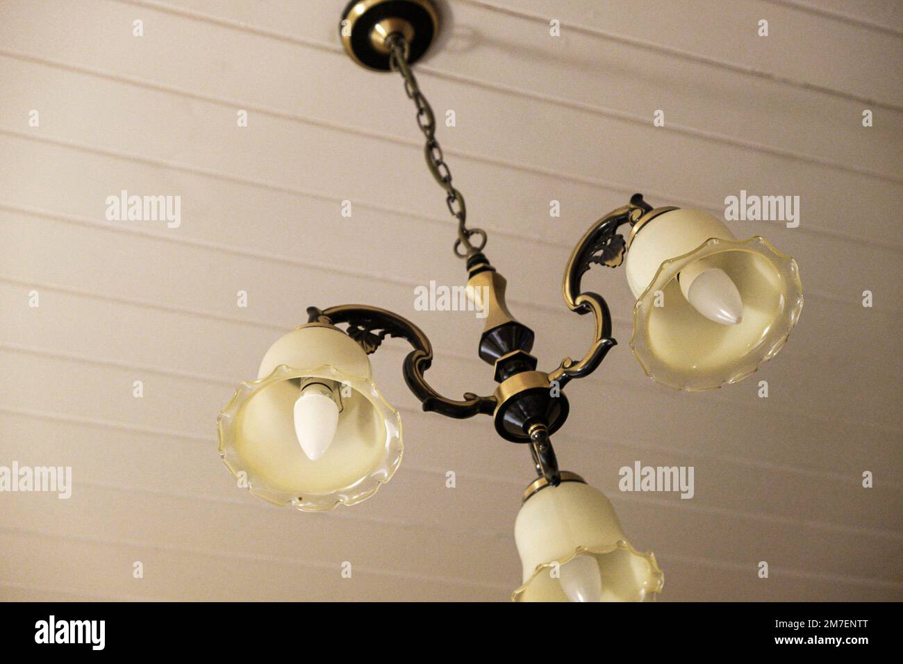 An old triple hanging lamp in an old hotel room Stock Photo - Alamy