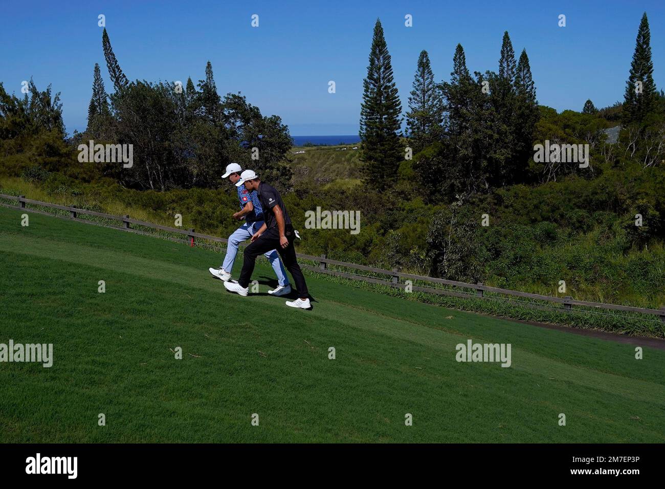 Collin Morikawa, right, and Matt Fitzpatrick walk up the 12th fairway ...