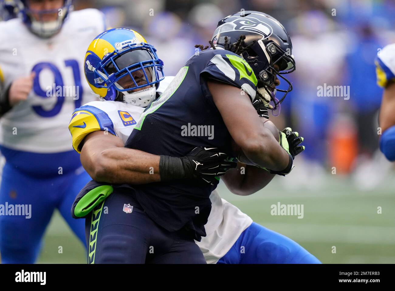 Seattle Seahawks running back DeeJay Dallas, right, is tackled by Los ...