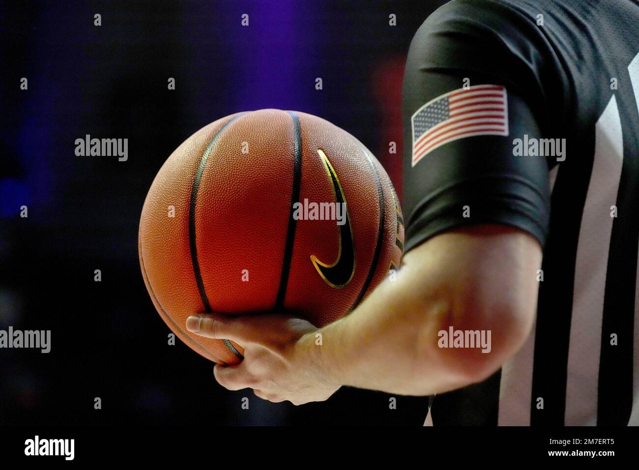 Referee Brian McNutt holds the game ball during a break in the action ...