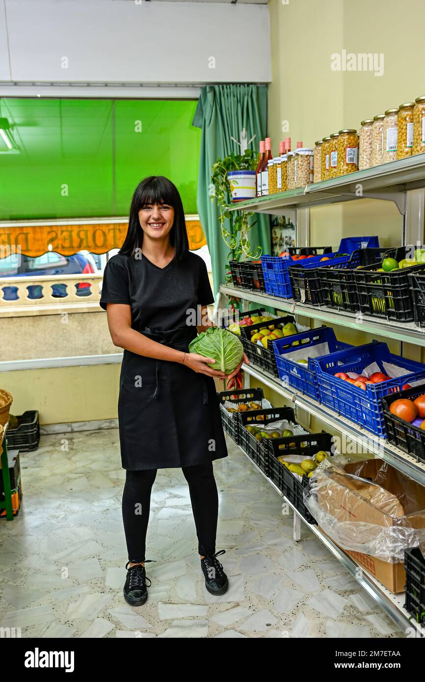 Portrait of shopkeeper in the greengrocer, showing a magnificent and ...