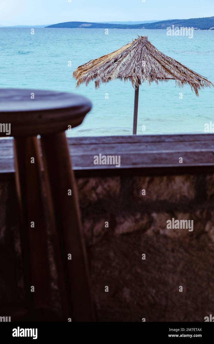 A single straw and reed parasol on an empty beach in Croatia Stock ...