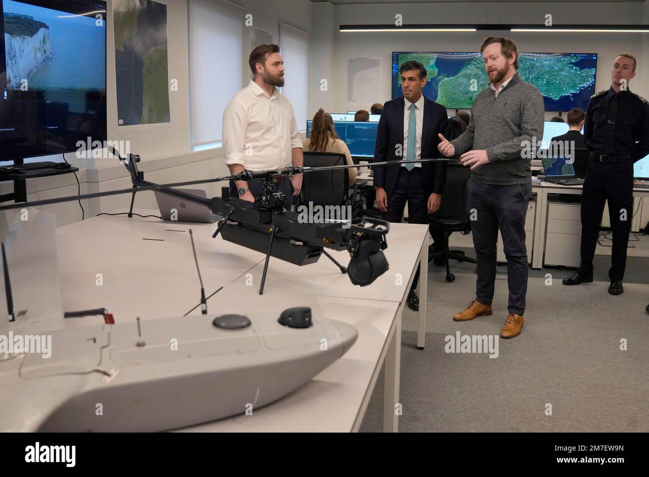 Britain's Prime Minister Rishi Sunak, centre, speaks to Border Force ...