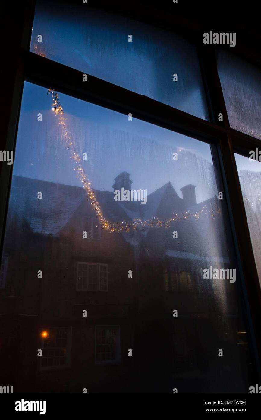 View through a coffee shop window to the night time street scene ...