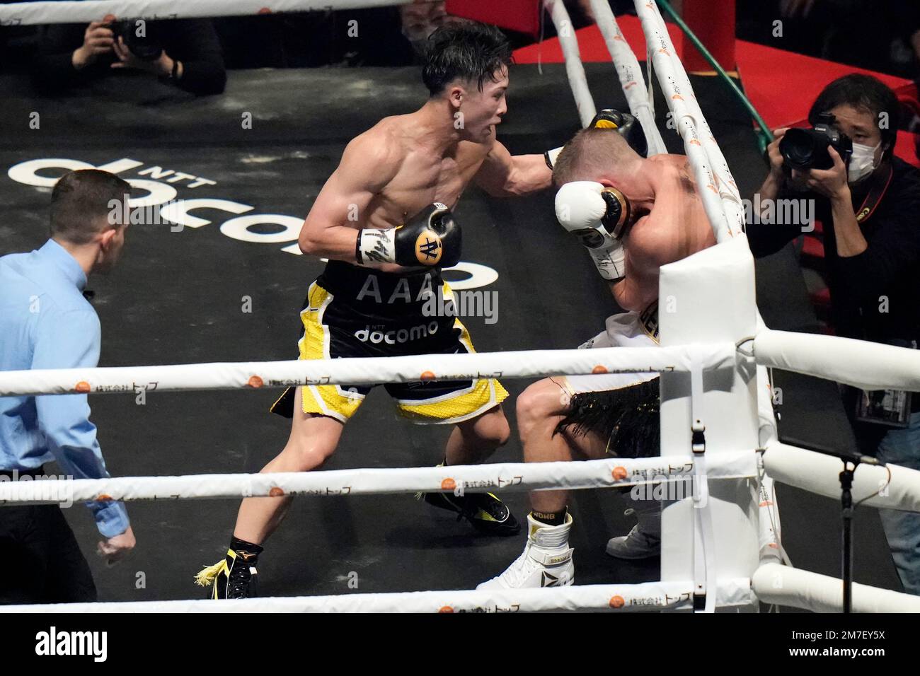 Naoya Inoue of Japan throws a punch Paul Butler of Britain during their ...