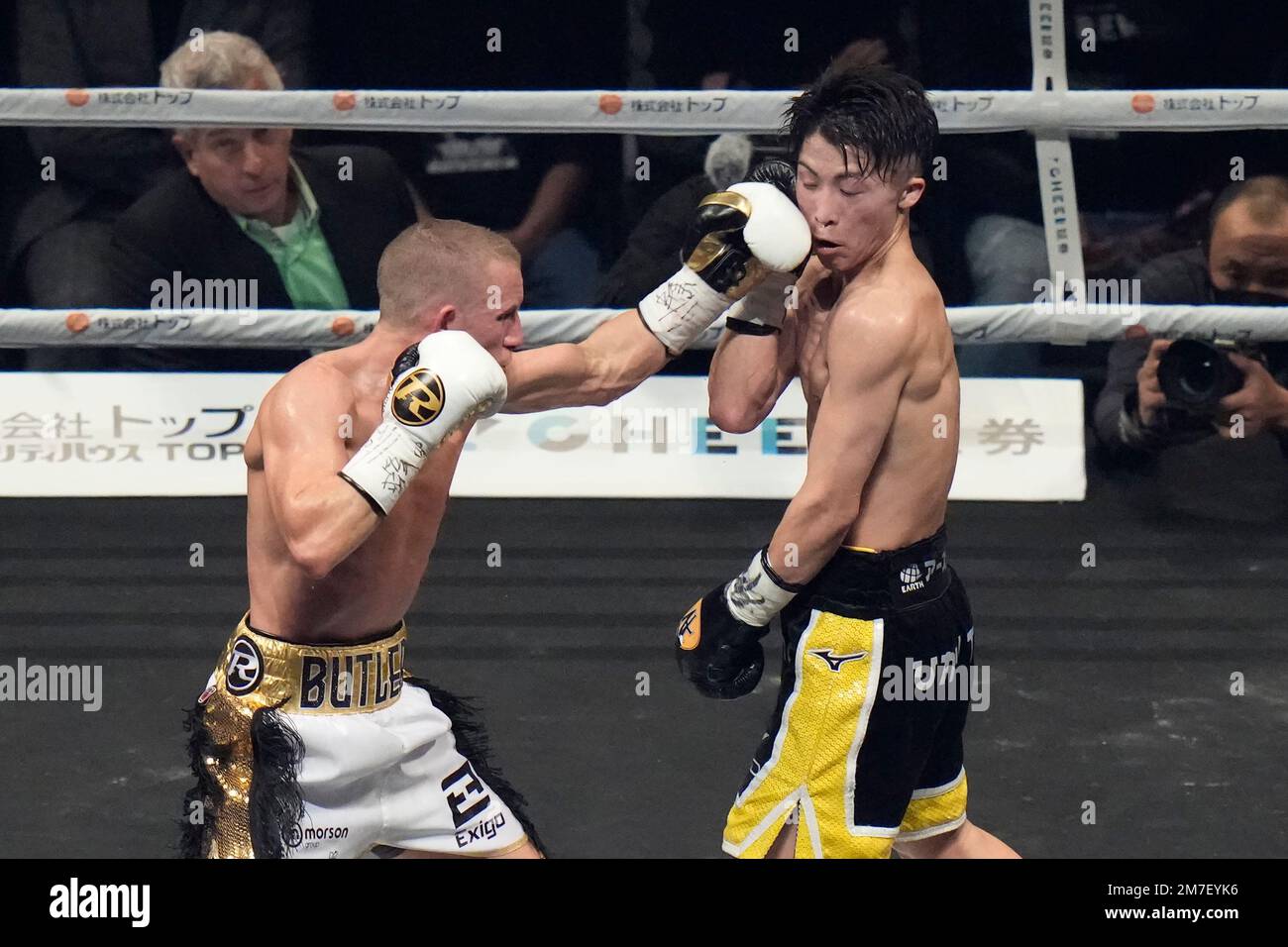 Paul Butler of Britain, left, throws a punch at Naoya Inoue of Japan ...