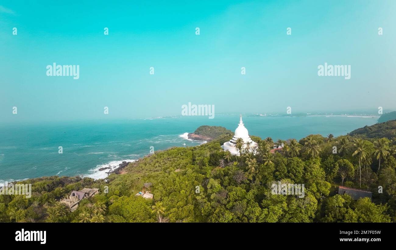an an aerial shot over the Rumassala Sanctuary near a jungle beach ...