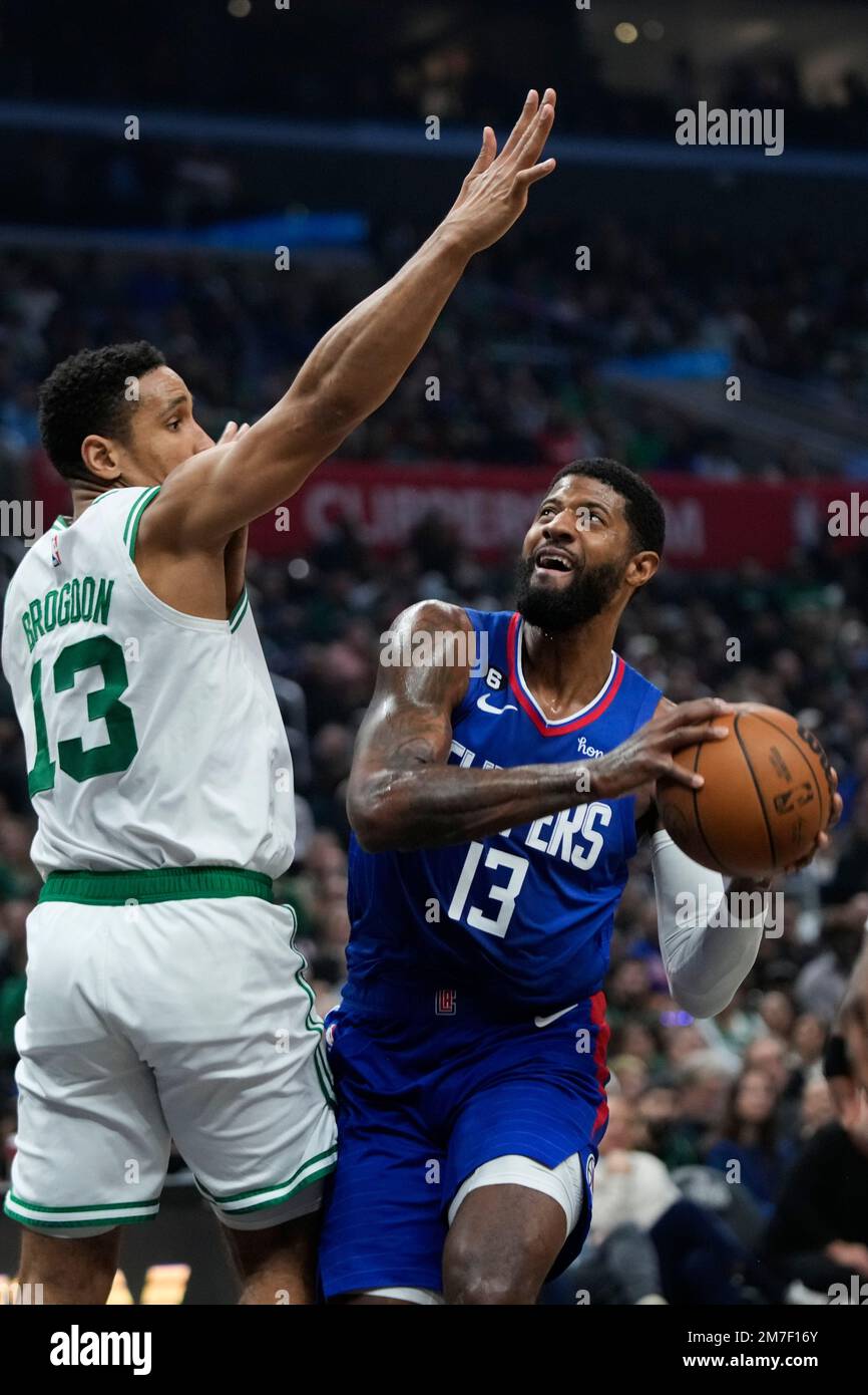 Los Angeles Clippers' Paul George, right, is defended by Boston Celtics ...