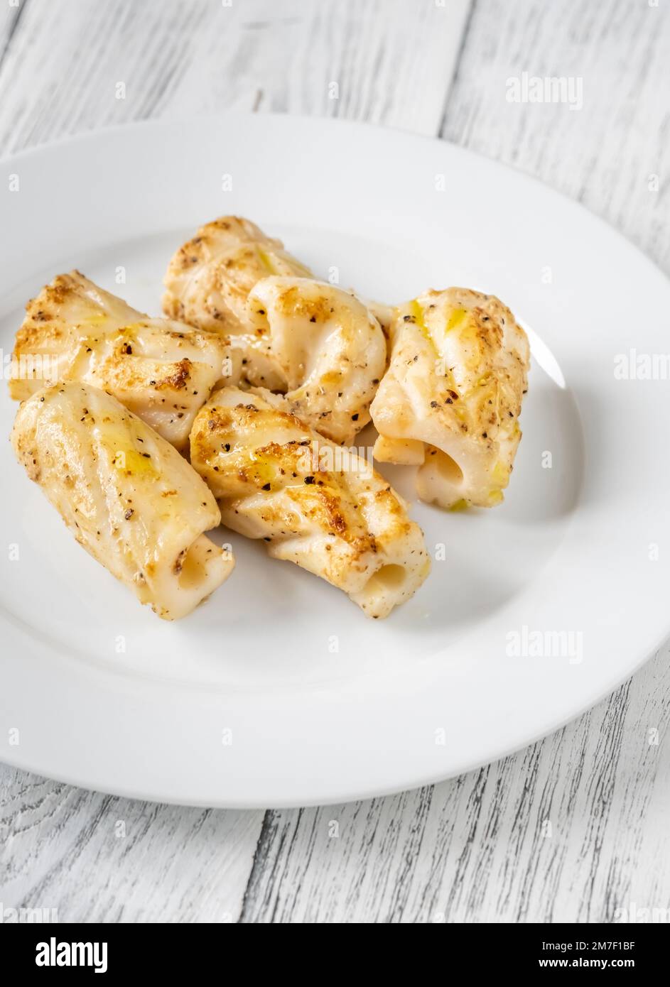 Portion of fried asian style calamari on the plate Stock Photo - Alamy