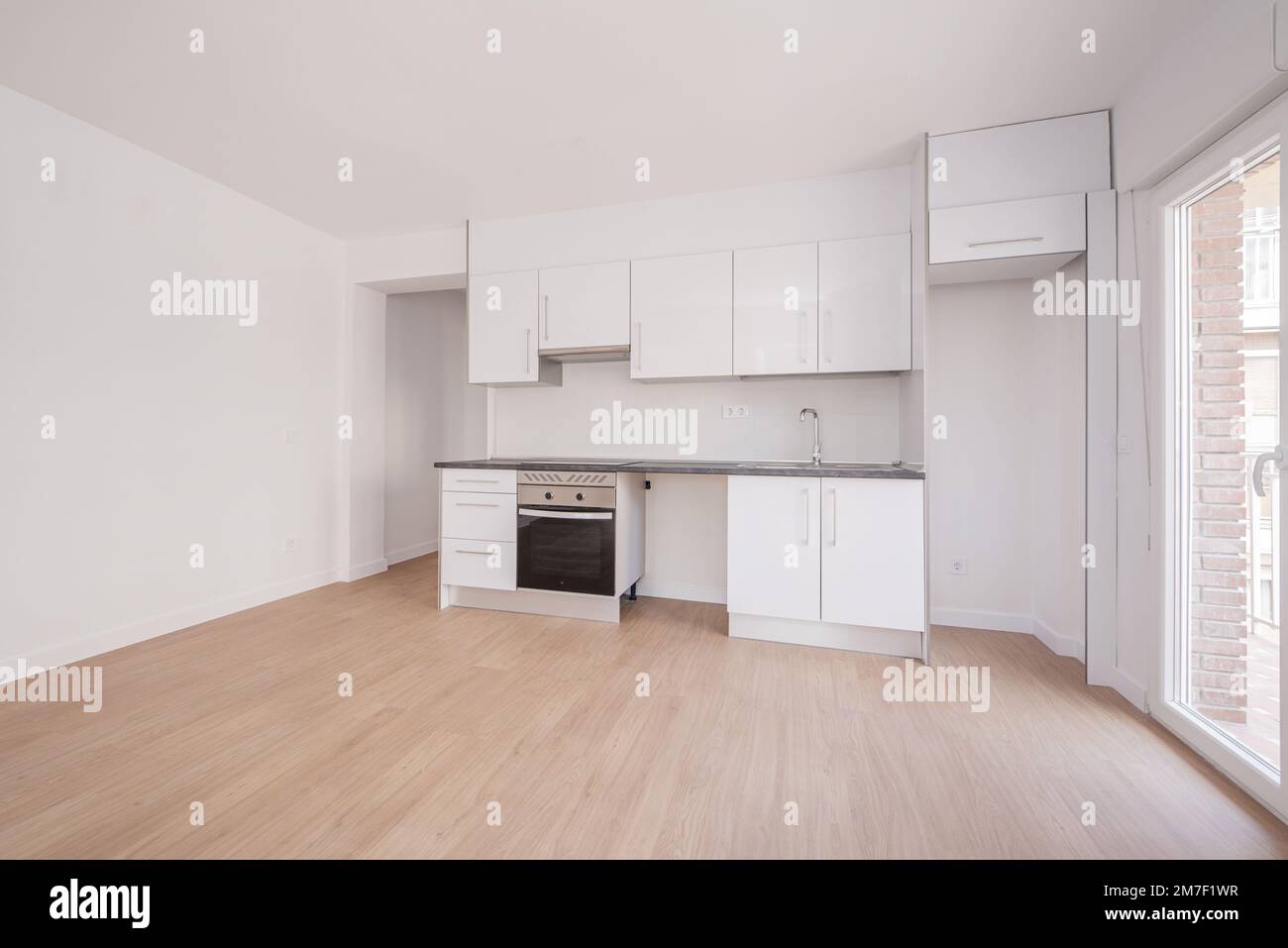 Open kitchen of a newly installed studio apartment that is still ...