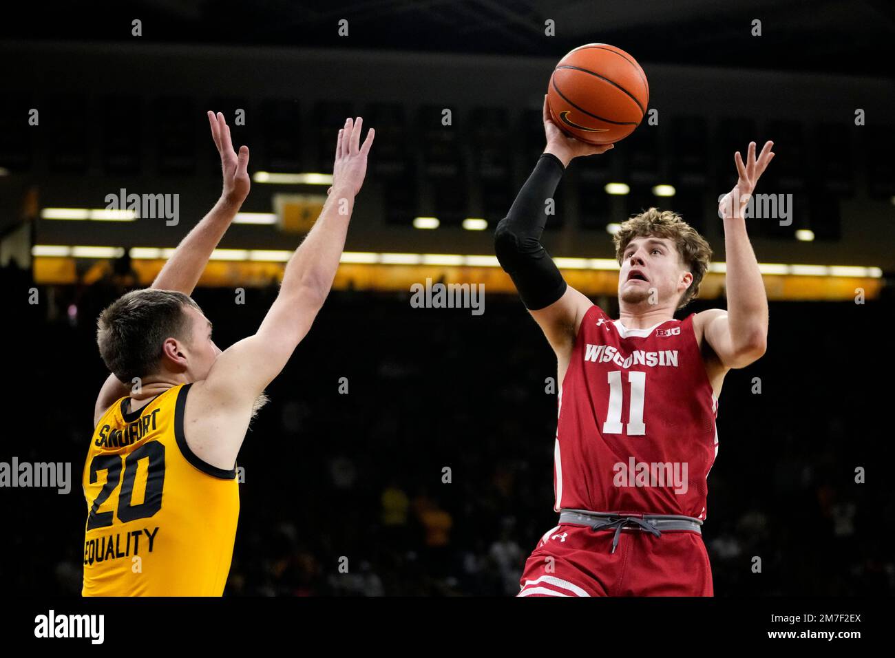 Wisconsin guard Max Klesmit (11) shoots over Iowa forward Payton ...