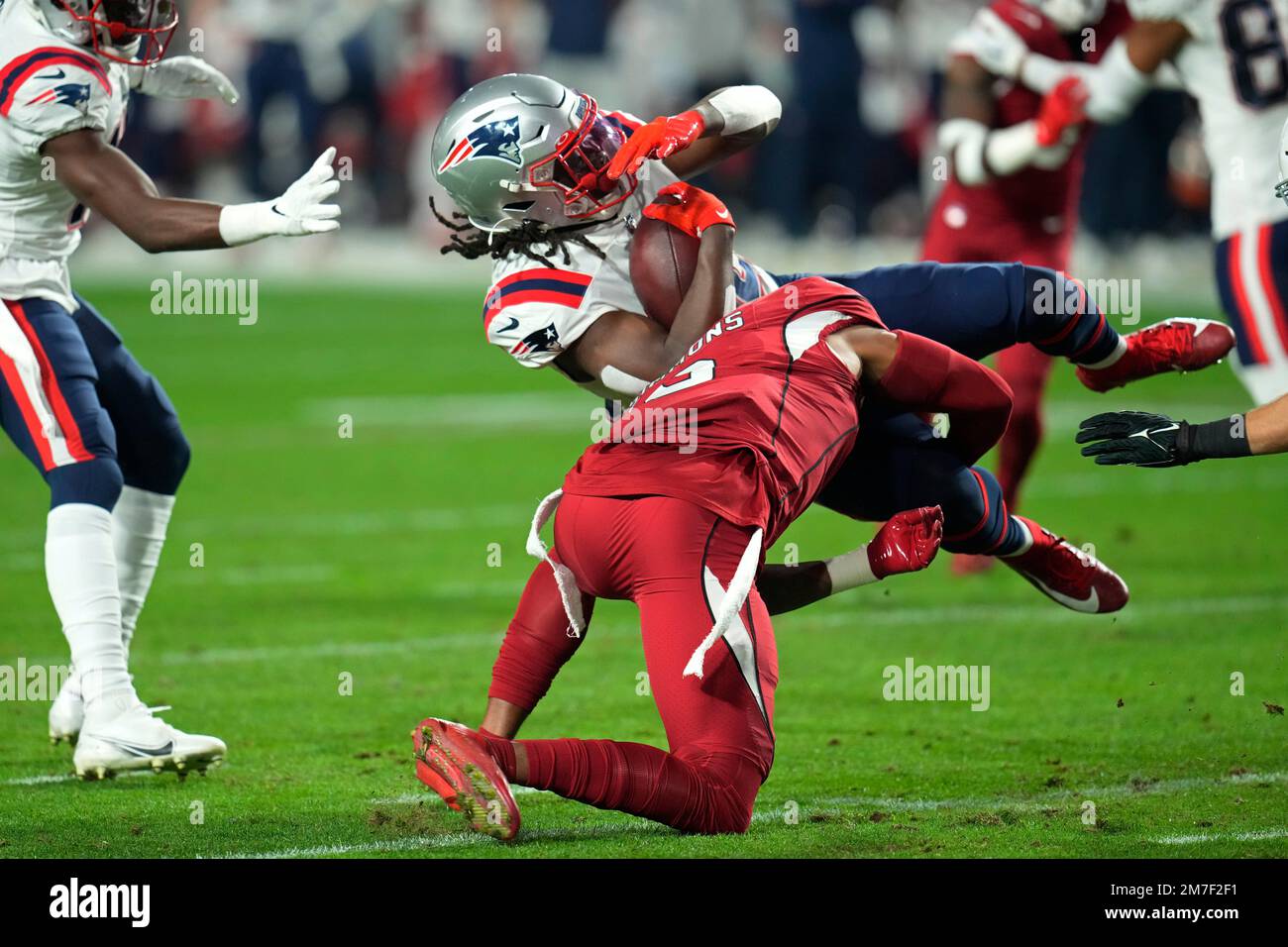 New England Patriots running back Rhamondre Stevenson (38) is tackled by Arizona Cardinals ...