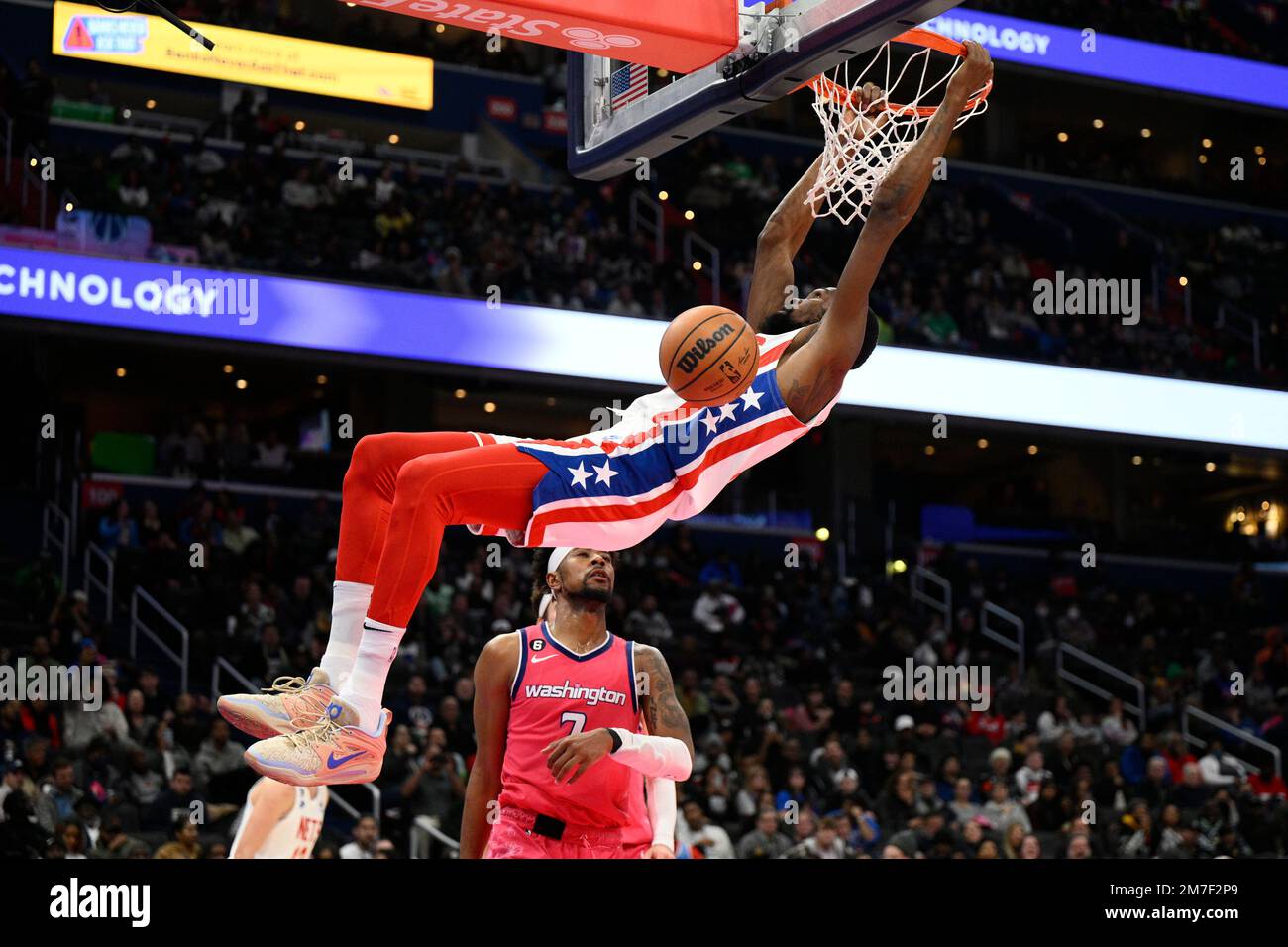 Brooklyn Nets forward Kevin Durant, top, hangs from the rim after ...