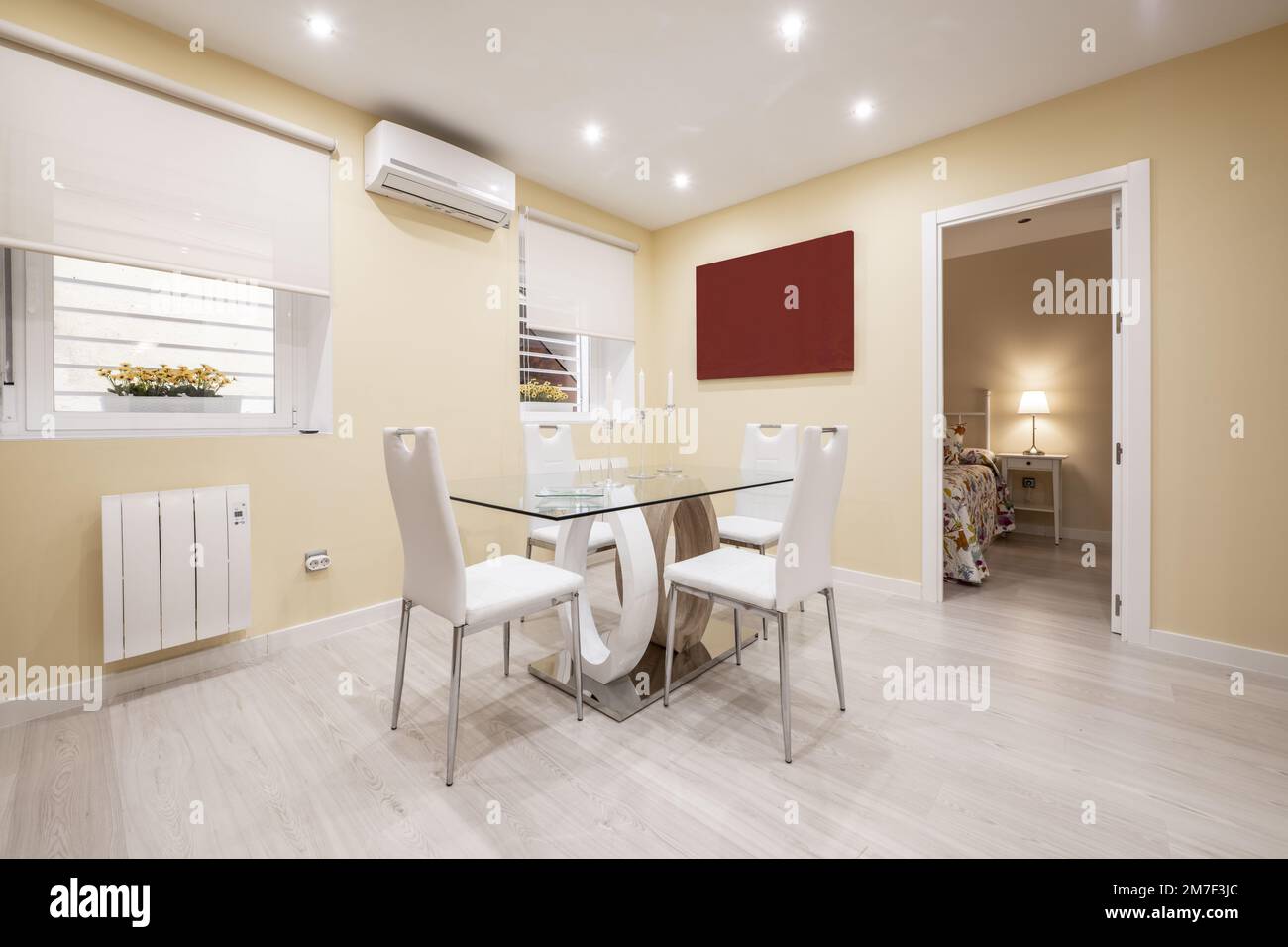 Living room with a glass table with white chairs in a room with ...