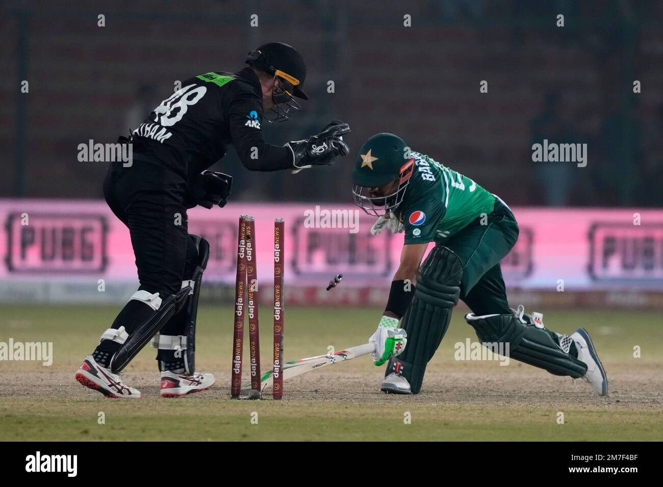Pakistan's Babar Azam, right, attempts unsuccessfully save his stump ...