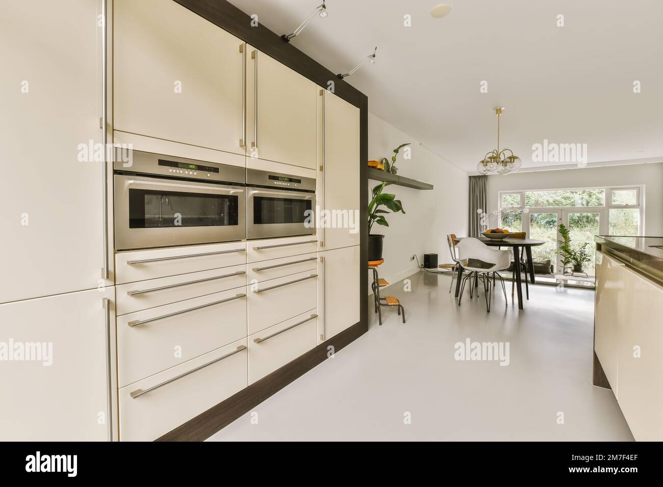 a modern kitchen with white cabinets and black counter tops in an open ...