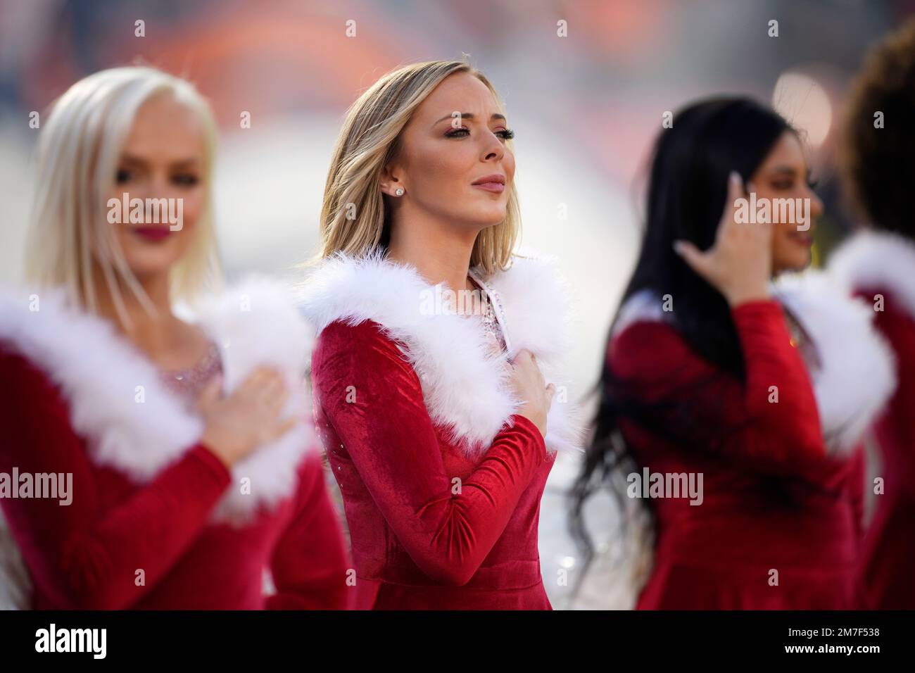 Denver Broncos cheerleaders dressed in holiday garb stand for the ...