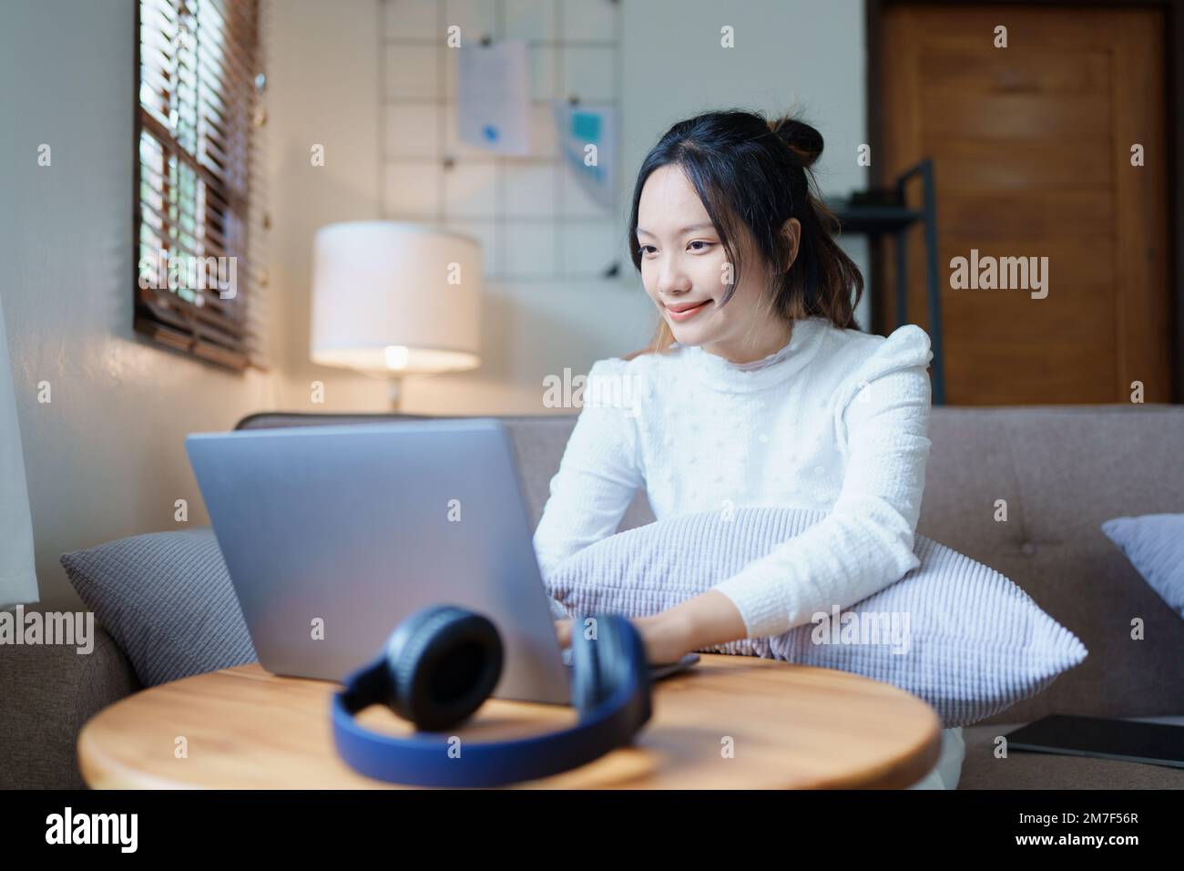 Portrait of a beautiful Asian teenage girl using a computer Stock Photo ...