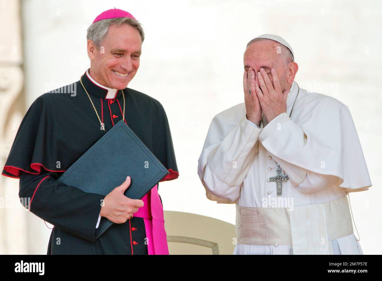 FILE - Pope Francis touches his face as he shares a word with ...