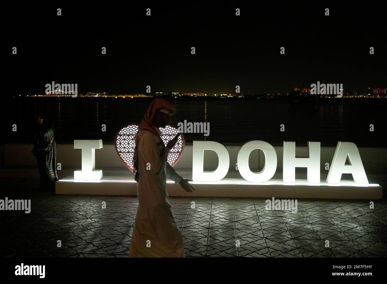 People walk along on Doha corniche in Doha, Qatar, Monday, Dec. 12 ...