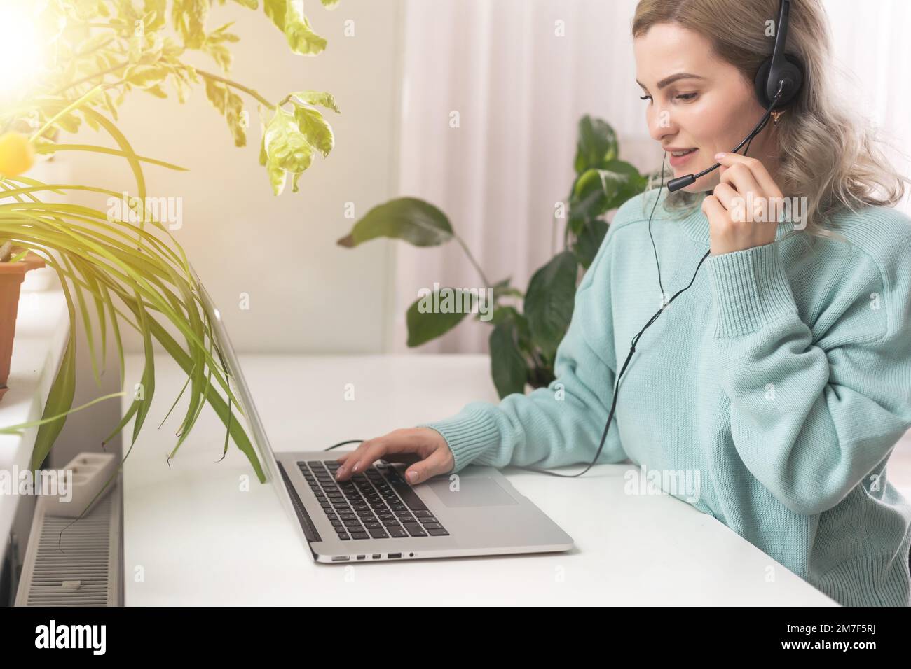 Side view head shot smiling mixed race lady freelancer wearing headset ...