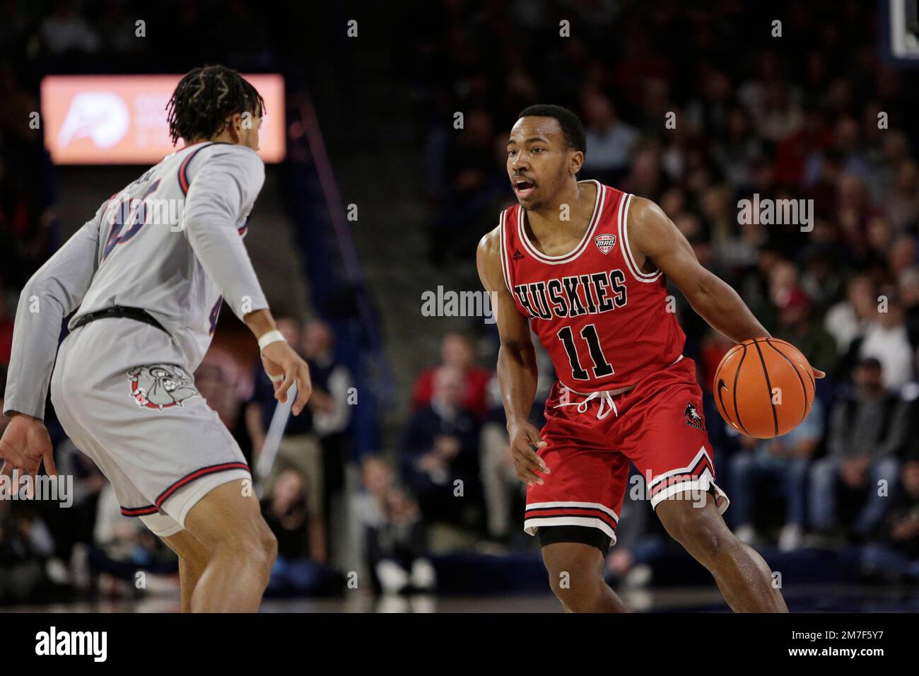 Northern Illinois guard David Coit, right, controls the ball while ...