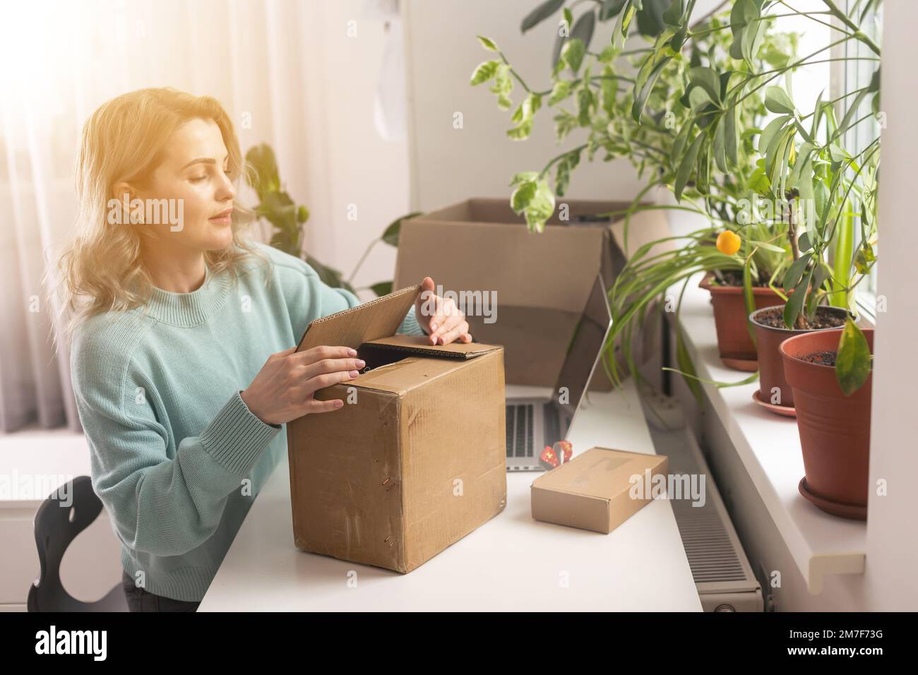 Small start-up business owners are packing boxes. To deliver to ...