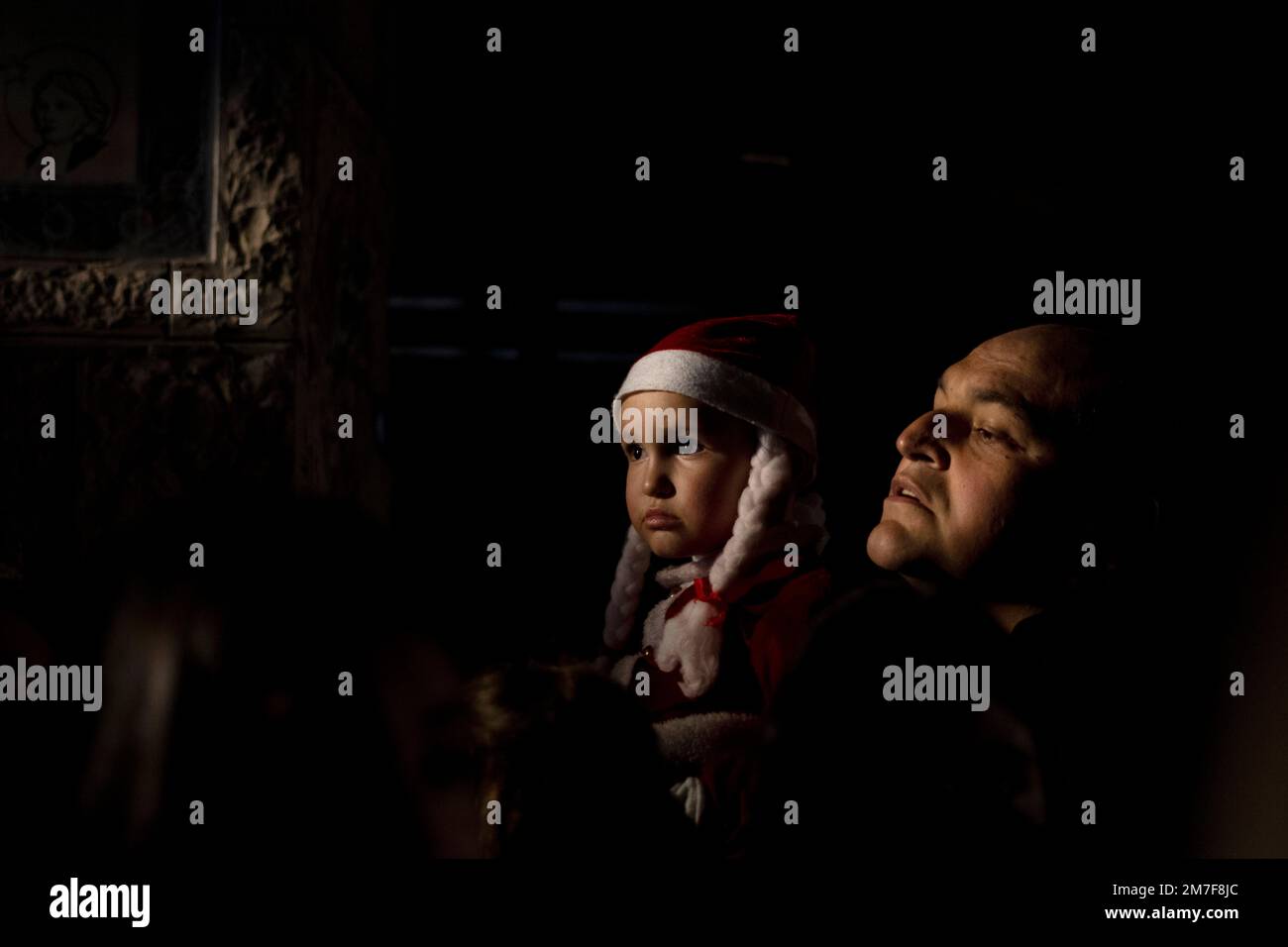 A child wears a tiny Santa Claus costume Jerusalem's Old City during ...