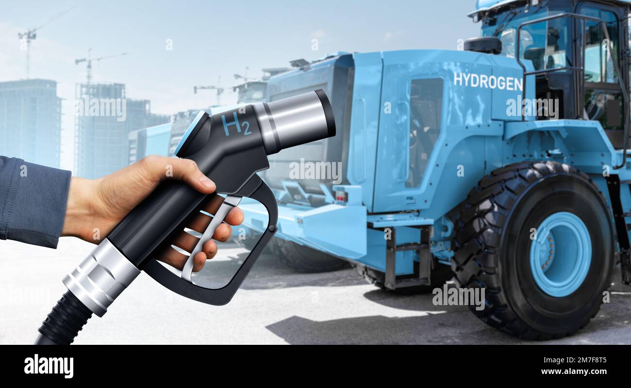 Hand with hydrogen fueling nozzle on a background of fuel cell ...