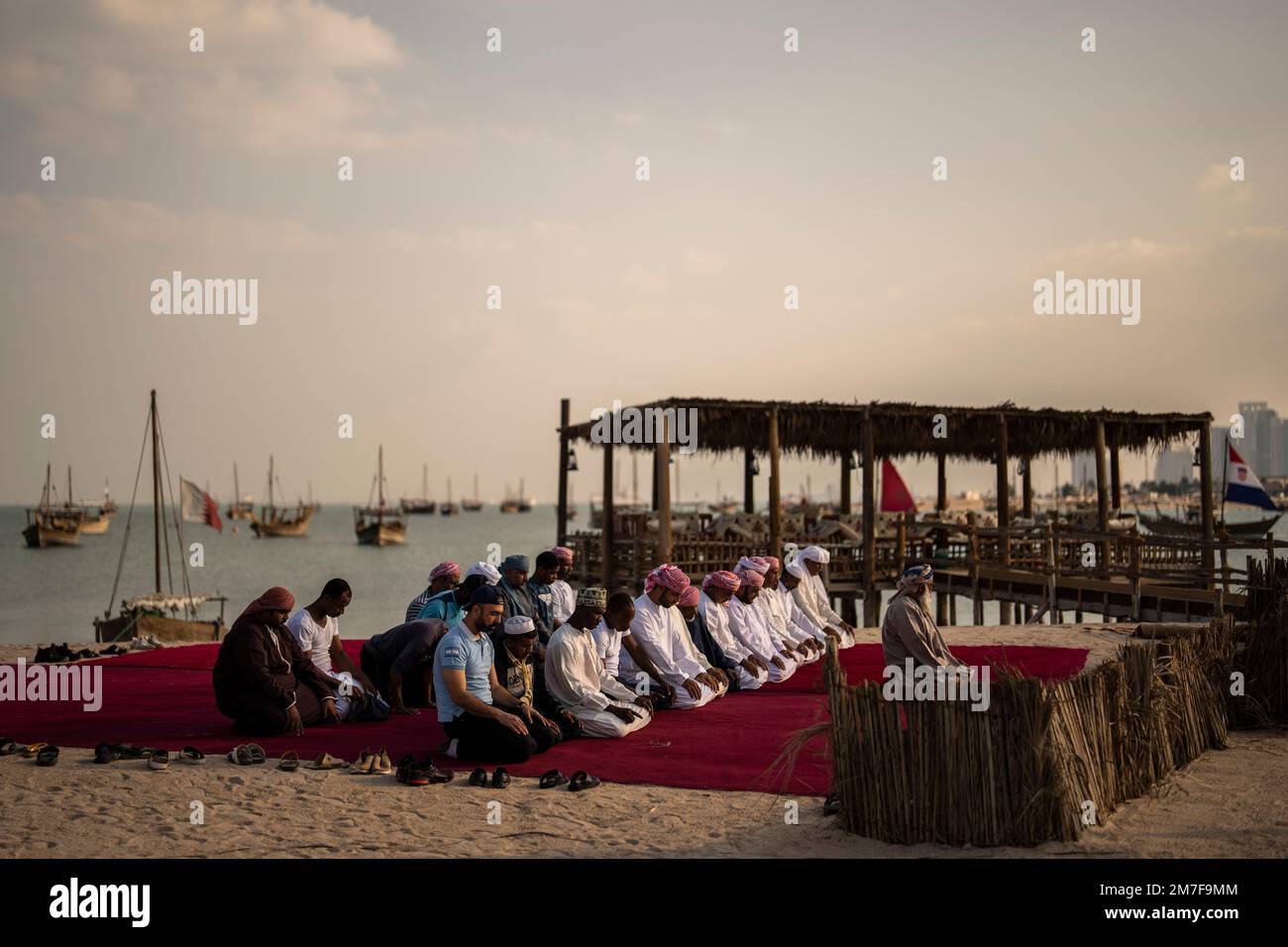 Men pray in Katara beach, Doha, Qatar, Monday, Dec. 12, 2022. (AP Photo ...