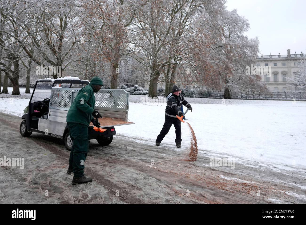 Workers spread grit in Green Park in London, Monday, Dec. 12, 2022 ...