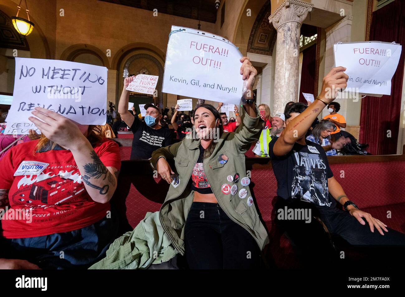 FILE - People hold signs and shout slogans as they protest before the ...