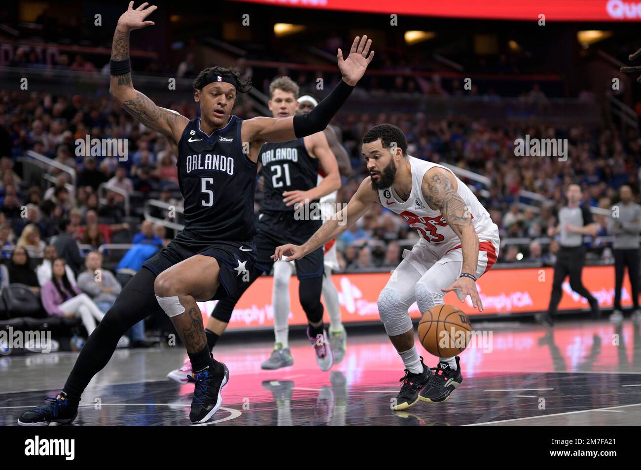 Toronto Raptors guard Fred VanVleet (23) is defended by Orlando Magic forward Paolo Banchero (5 ...