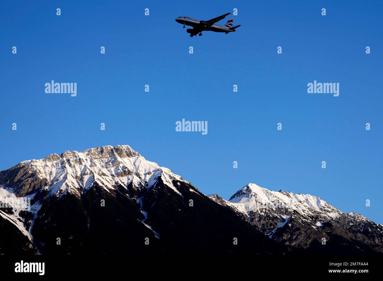 A British Airways plane flies low over the Alps on approach to ...