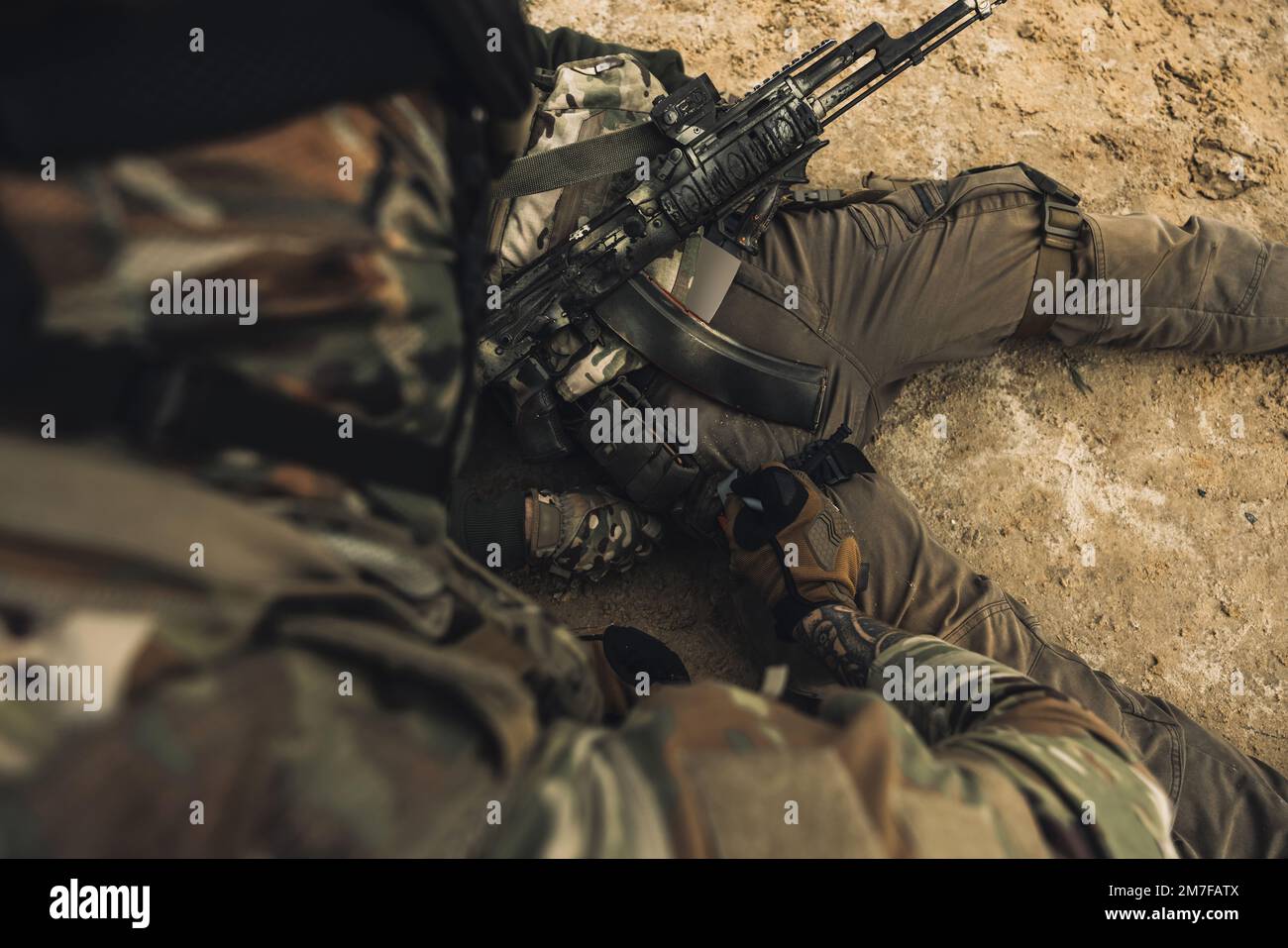Soldier lying on ground gun hi-res stock photography and images - Alamy
