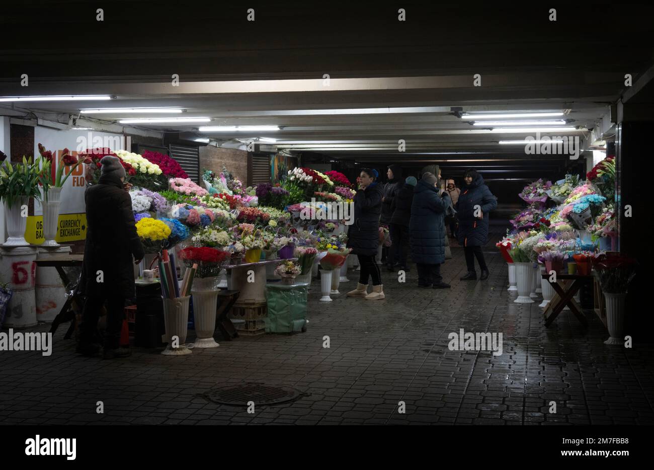 Flower sellers chat in an underground crosswalk in central Kyiv ...