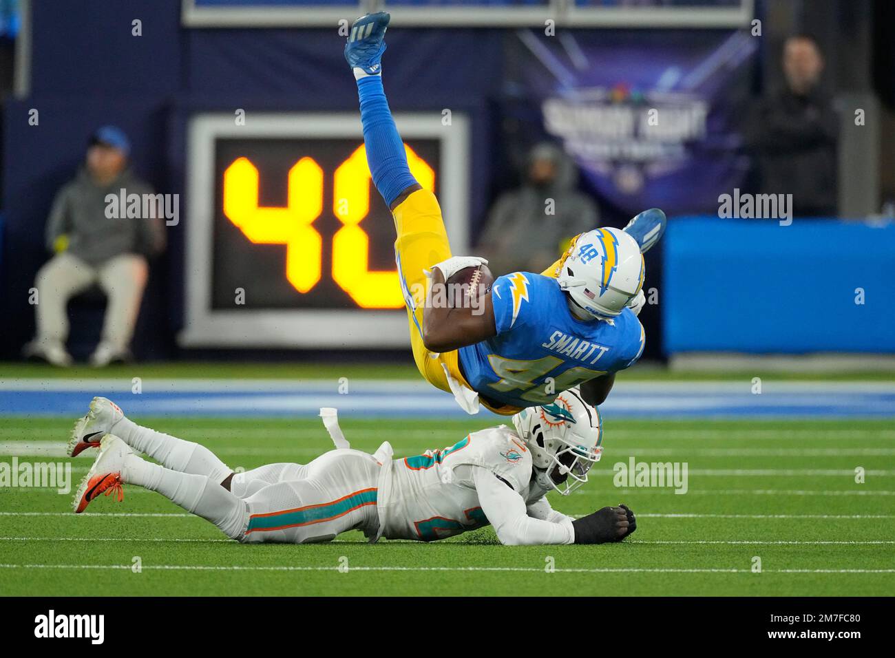 Los Angeles Chargers tight end Stone Smartt, top, is tackled by Miami ...