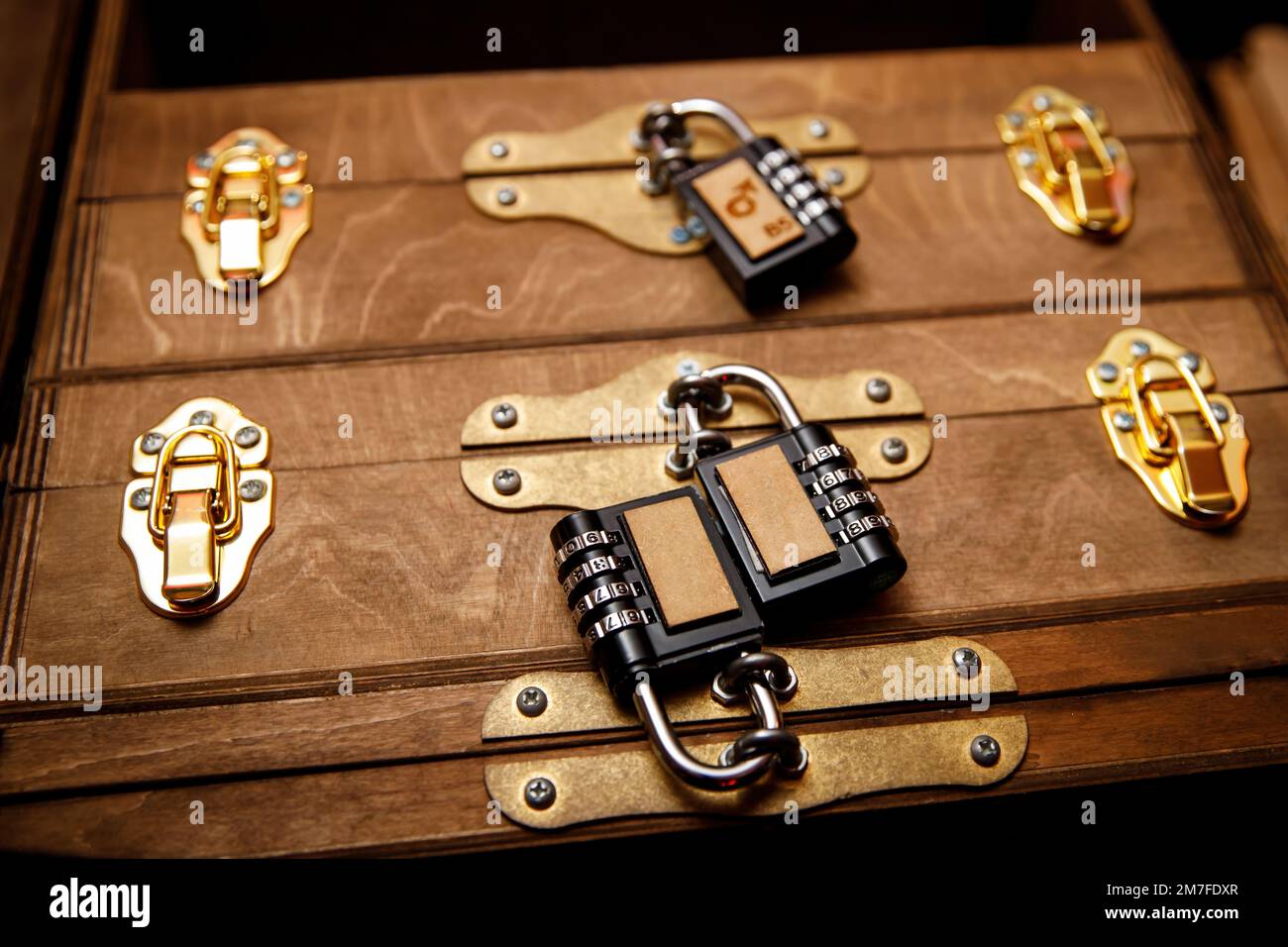 Old wooden boxes closed with a combination lock Stock Photo - Alamy
