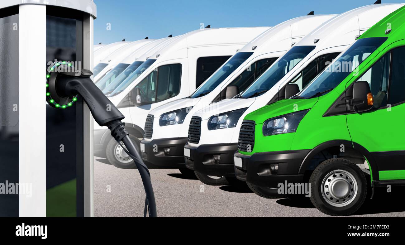 Electric vehicles charging station on a background of a row of vans ...