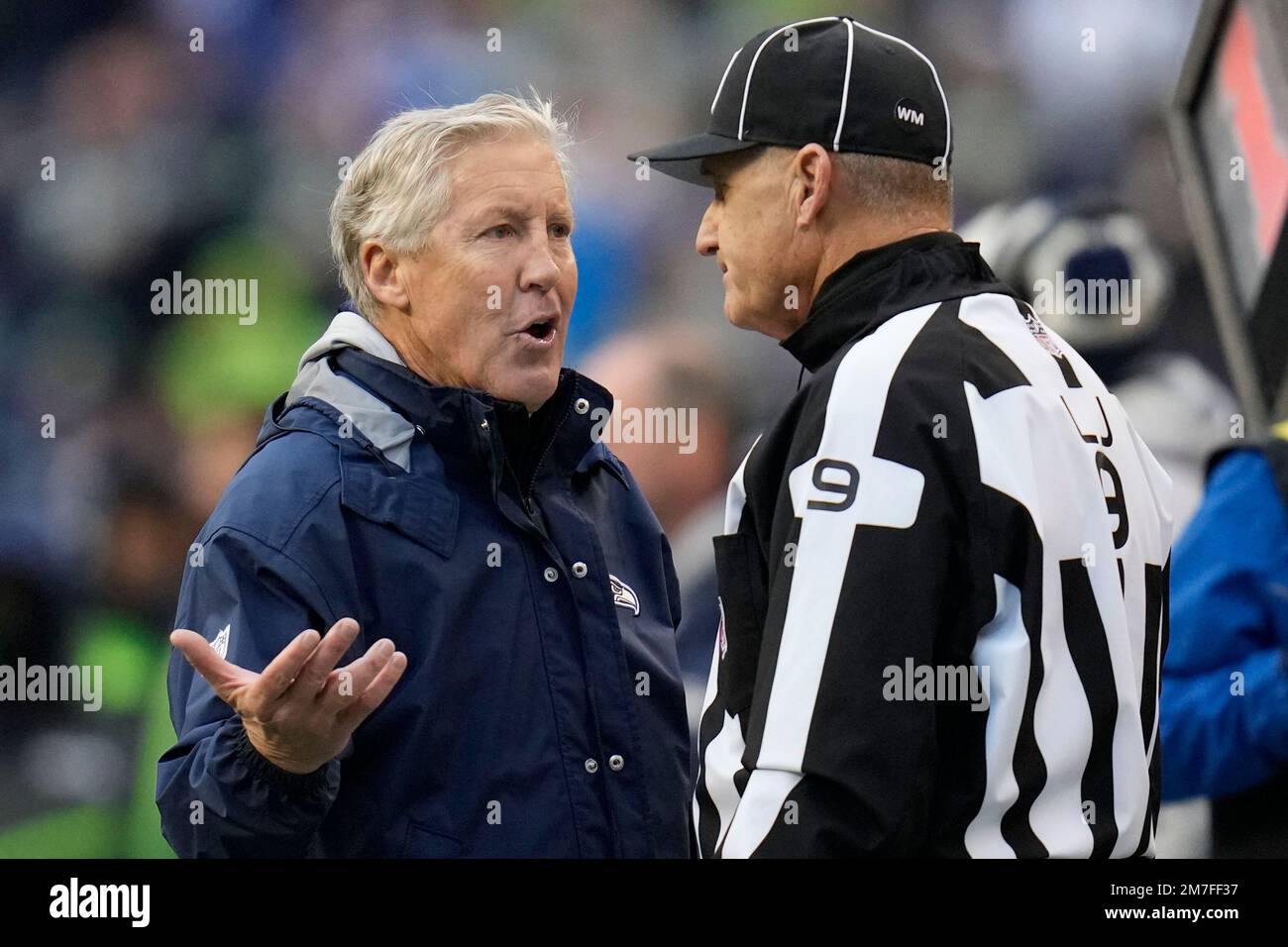 Seattle Seahawks head coach Pete Carroll speaks with line judge Mark ...