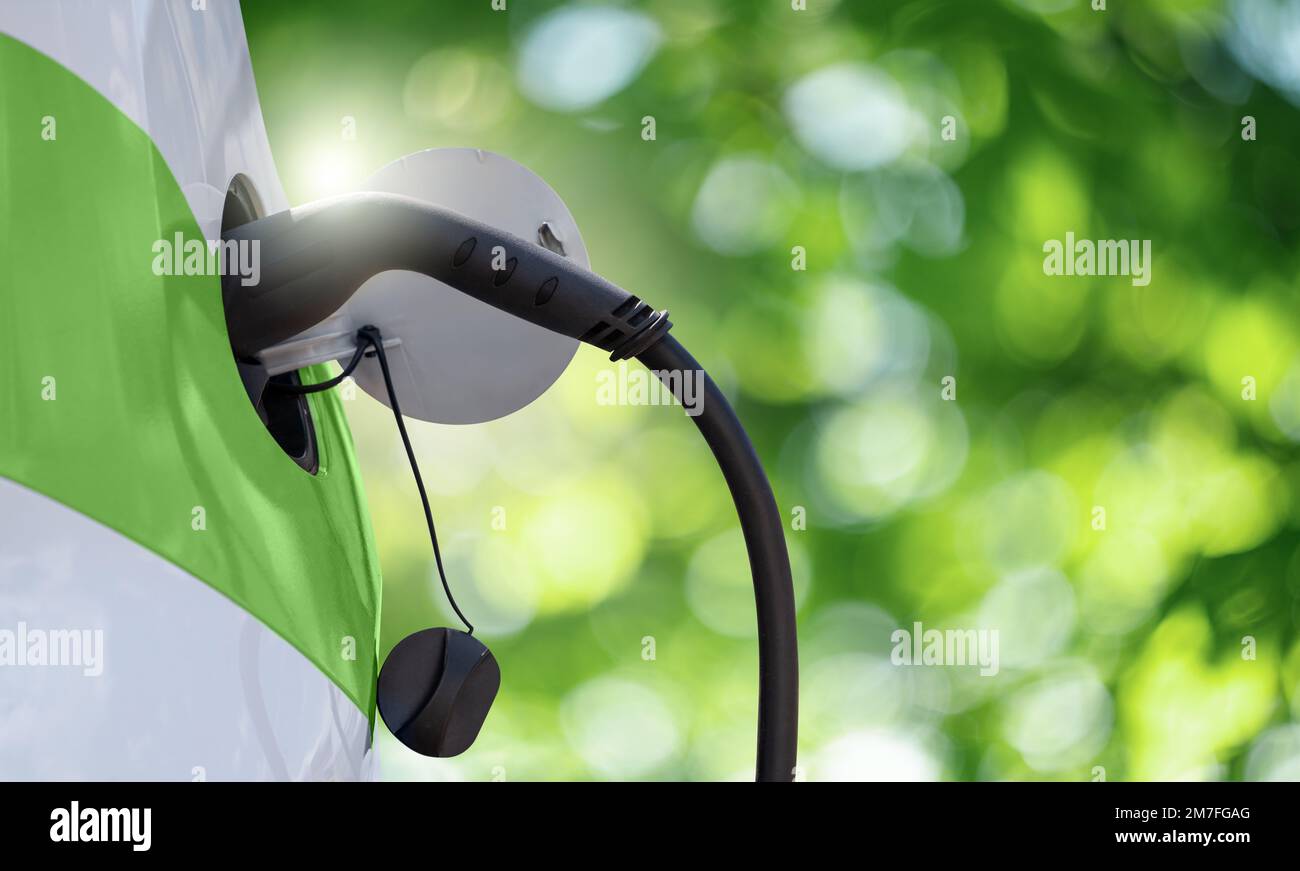 Close up of electric car inlet with a connected charging cable on a ...
