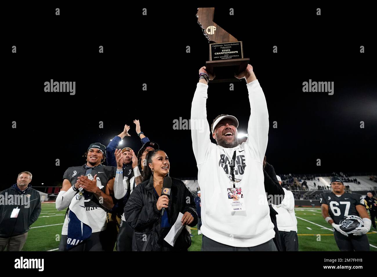 St. John Bosco head coach Jason Negro holds up the championship trophy ...