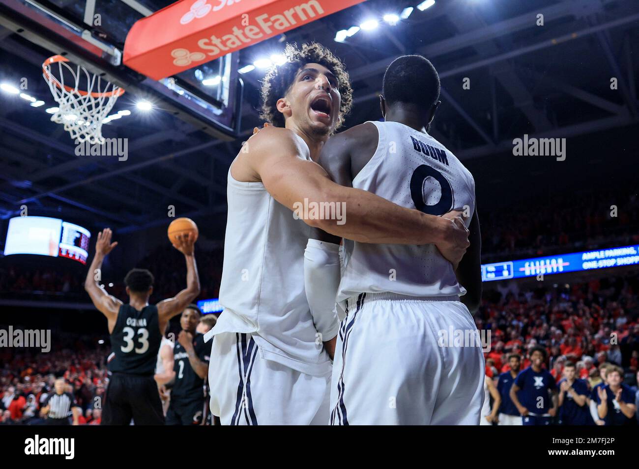 Xavier's guard Colby Jones, left, reacts as he holds onto Souley Boum ...