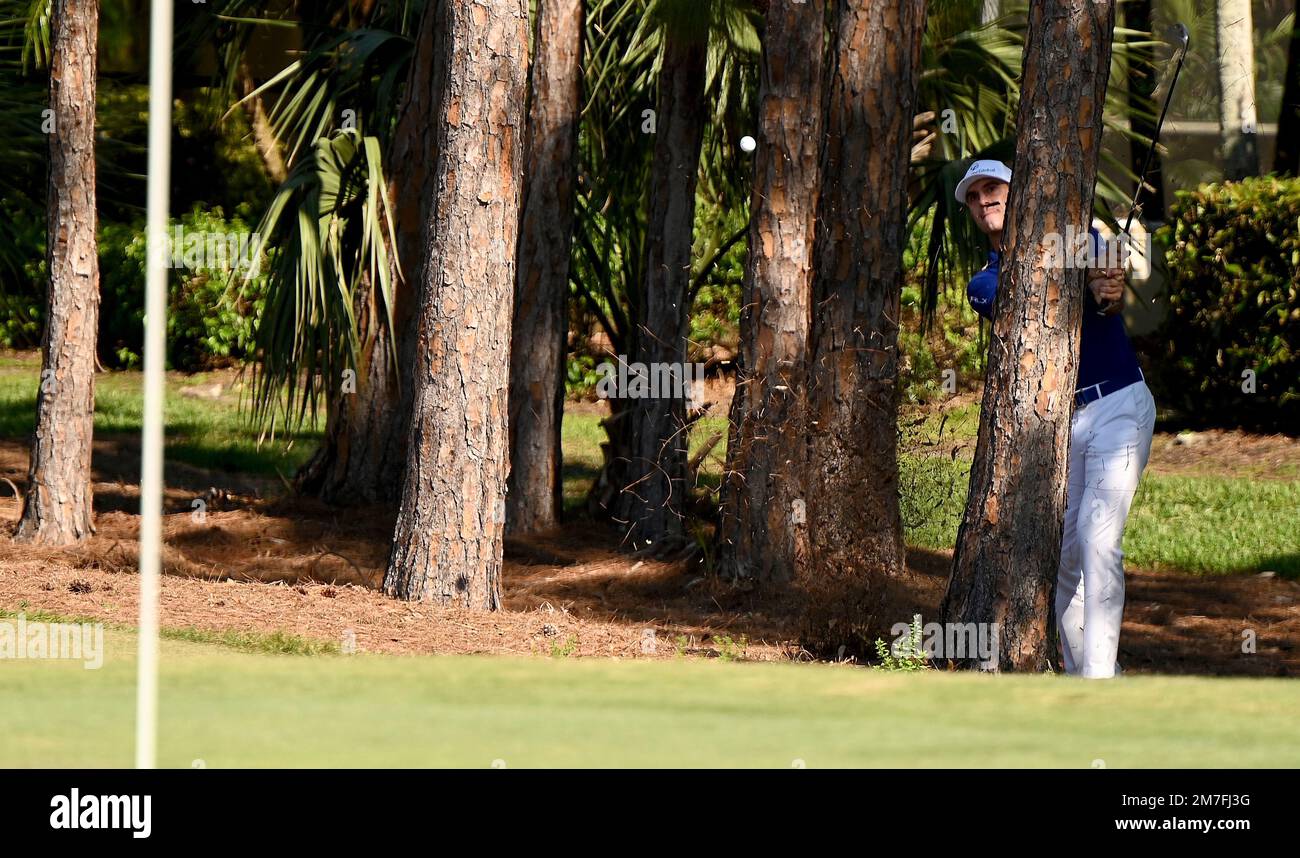 Camron Young chips onto the green from behind a tree during the second ...