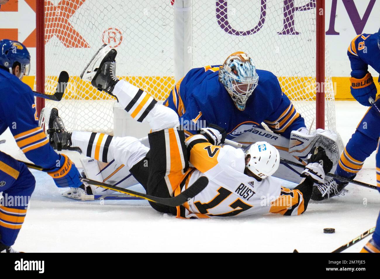 Pittsburgh Penguins' Bryan Rust (17) falls in front of Buffalo Sabres ...