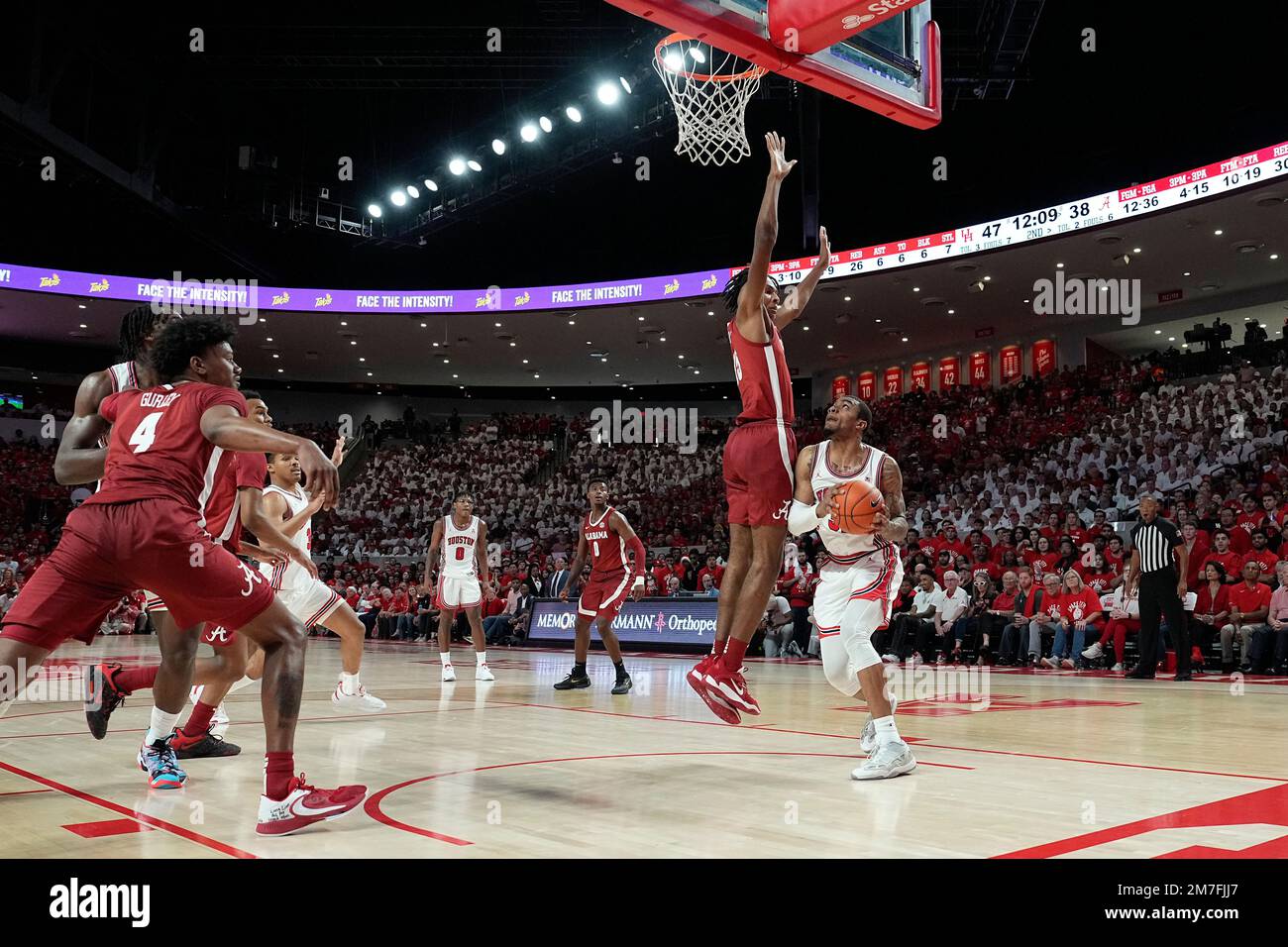 Houston forward Reggie Chaney (32), right, is defended by Alabama ...