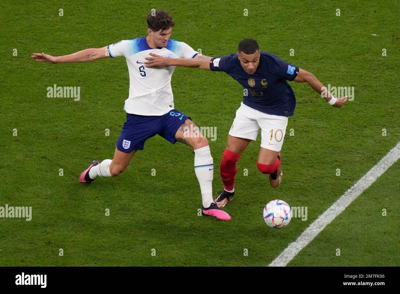 England's John Stones, left, and France's Kylian Mbappe fight for the ...