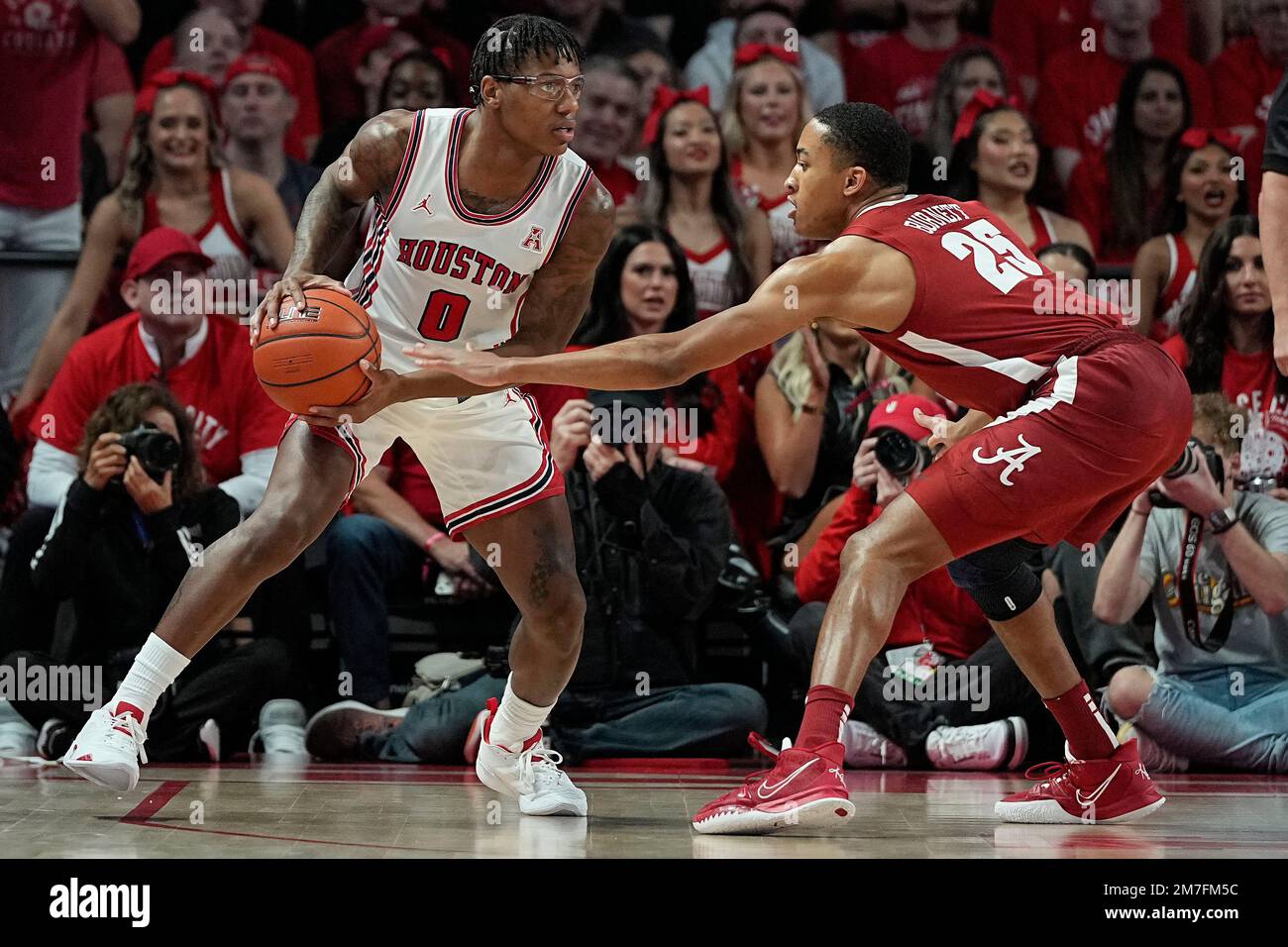 Houston guard Marcus Sasser (0) is defended by Alabama guard Nimari ...